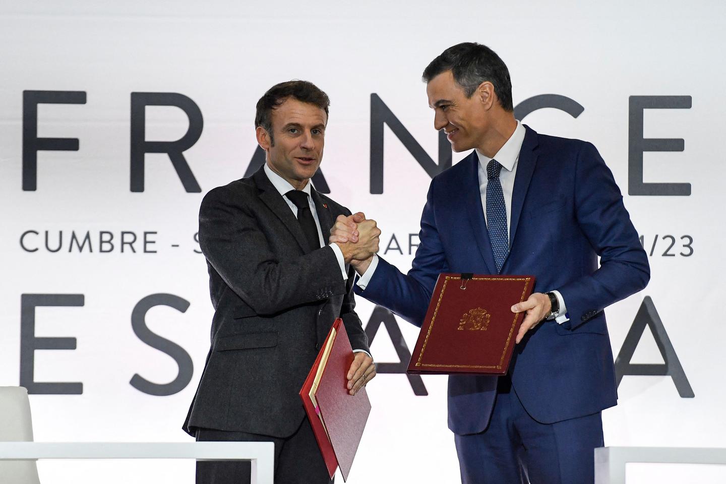 Macron signs friendship deal in Spain as France goes on strike