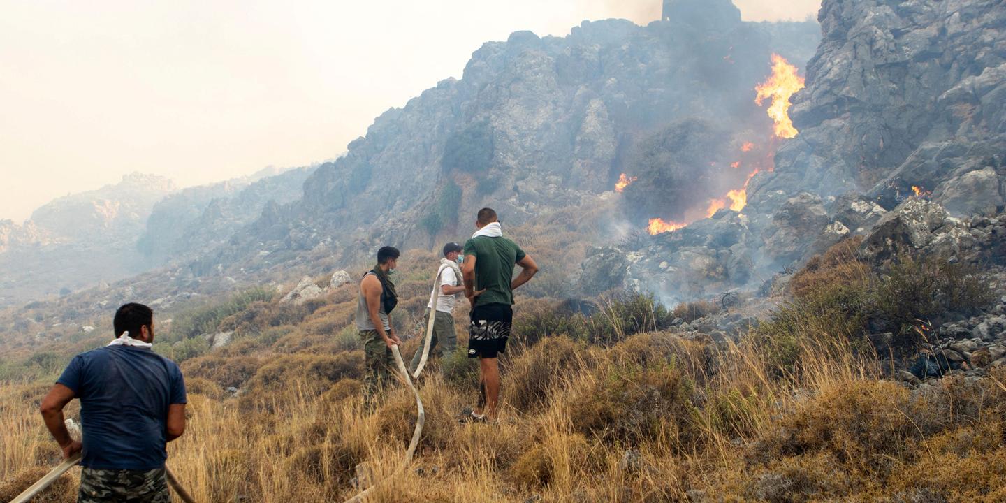 Thousands flee Greek island fires as heatwave continues around the world