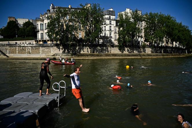 Paris Mayor Anne Hidalgo holds promise and takes a dip in the Seine