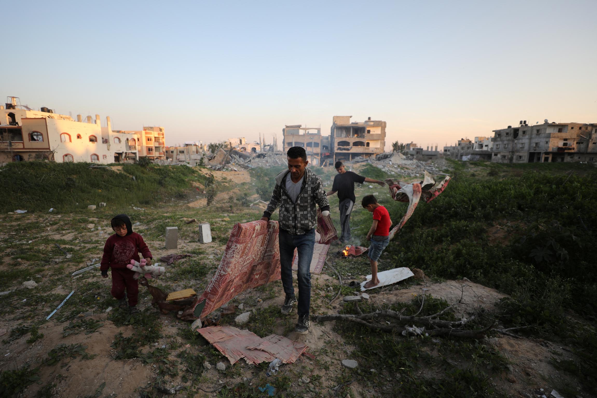 Gazans' return to a field of ruins, in pictures: 'We're all happy to be ...