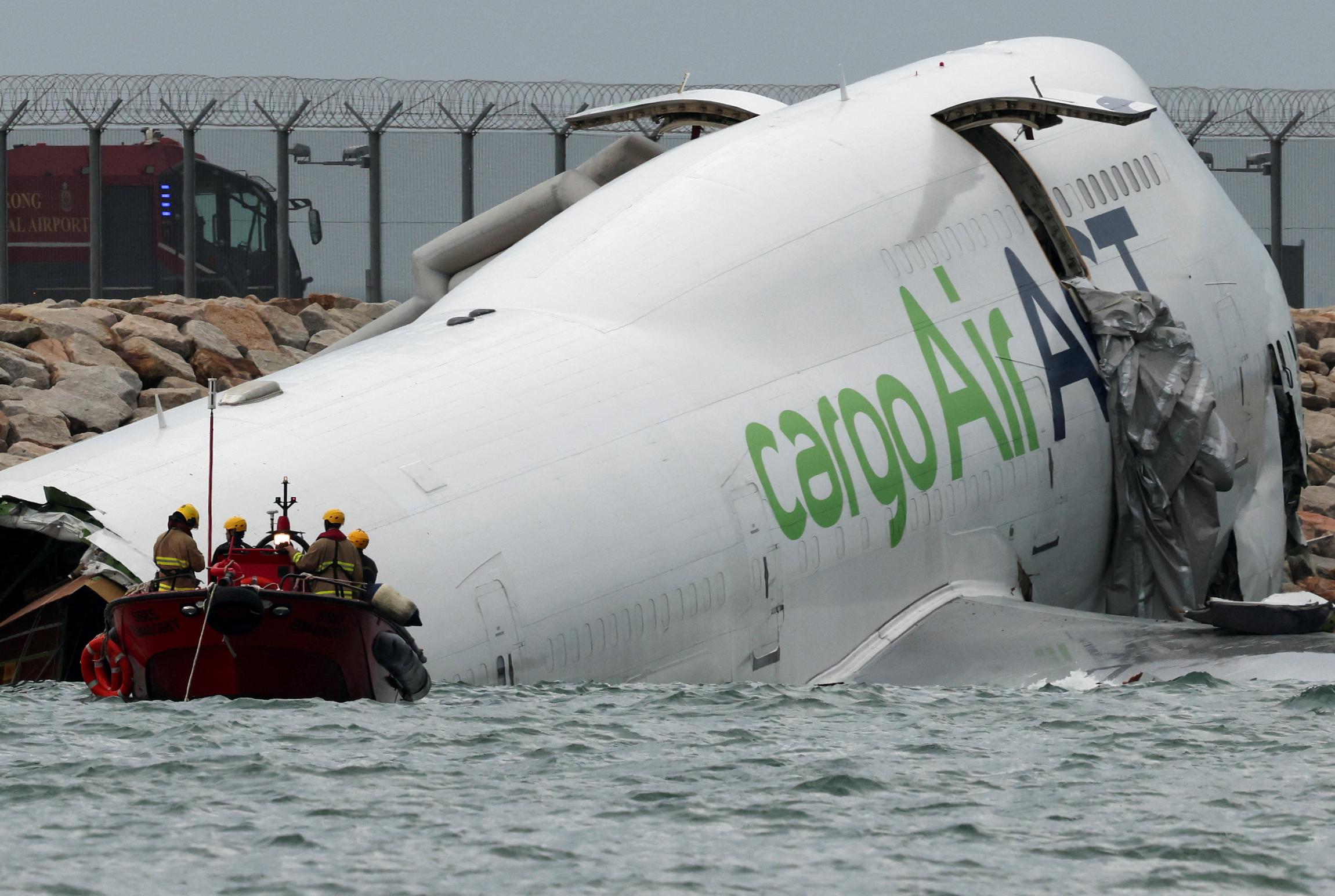 Cargo plane skids off Hong Kong runway, killing two
