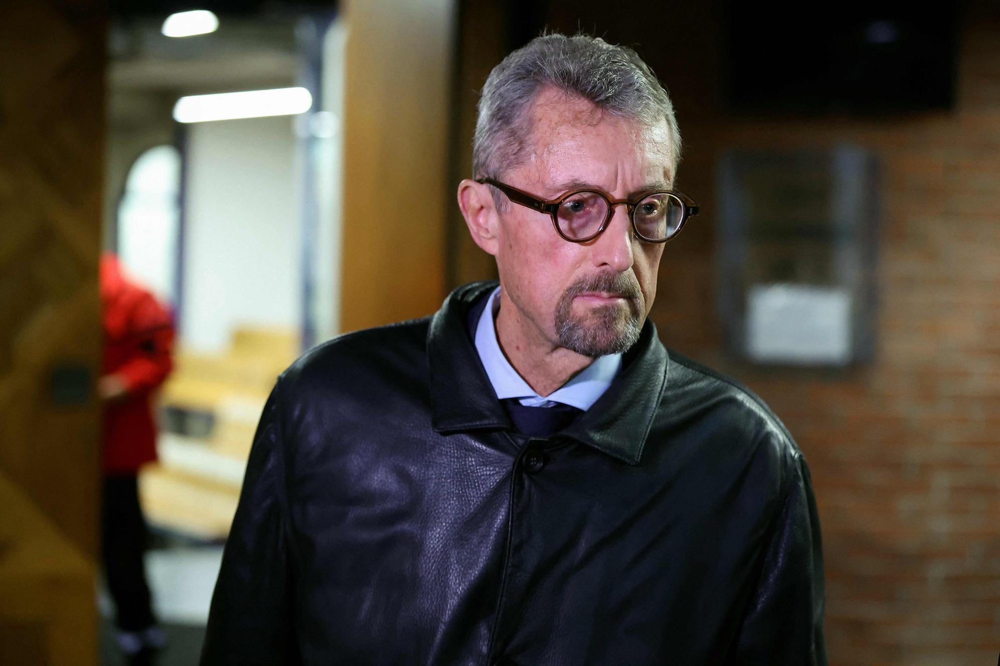 French former intelligence chief denies wrongdoing at extortion trial
