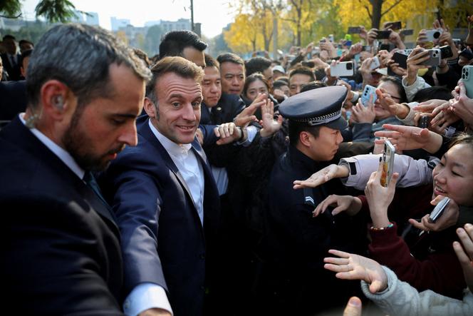 Macron receives rockstar greeting from students in China while wife ...